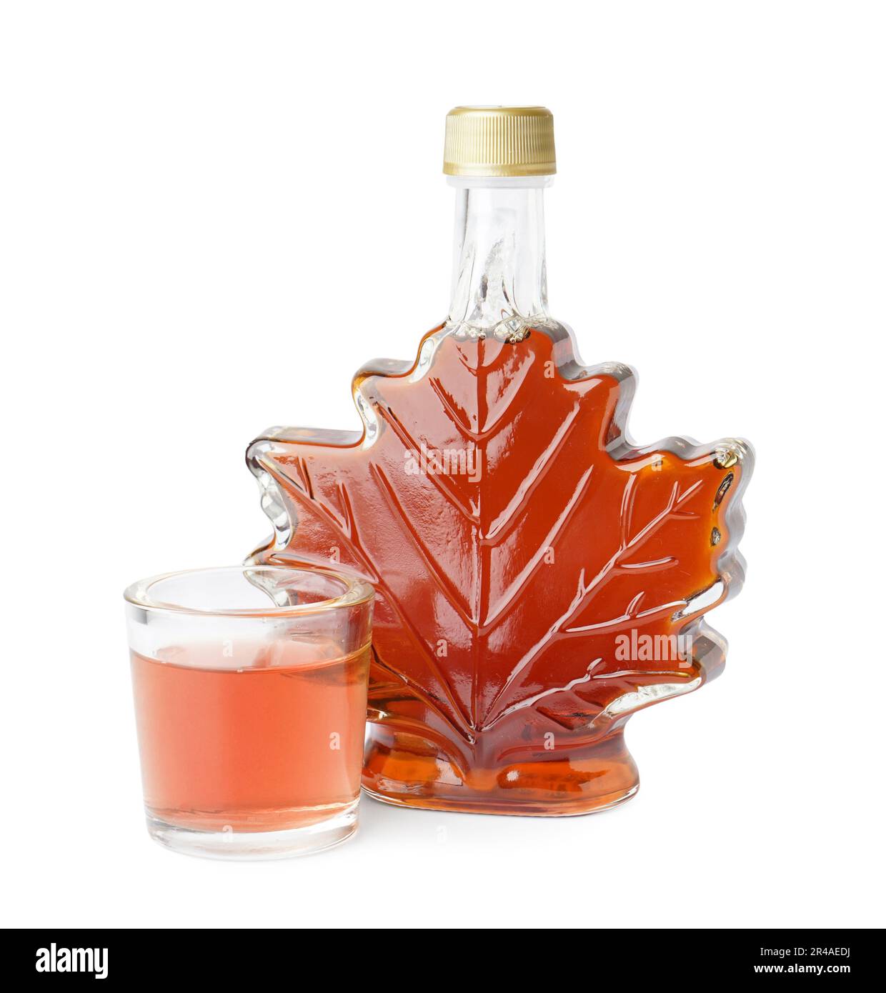Bottle and glass of sweet maple syrup isolated on white background ...