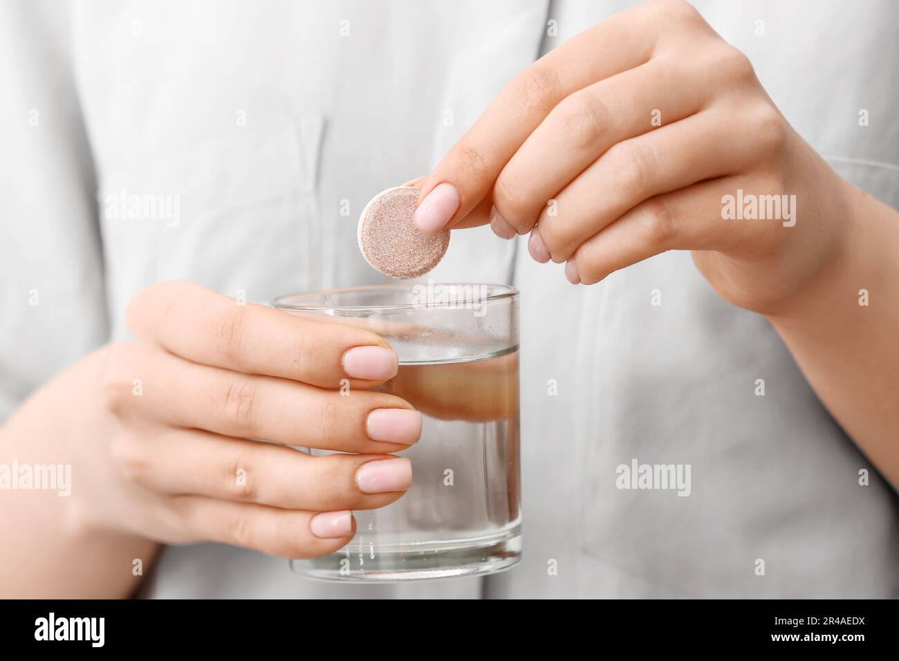 Woman putting effervescent pill hi-res stock photography and images - Alamy