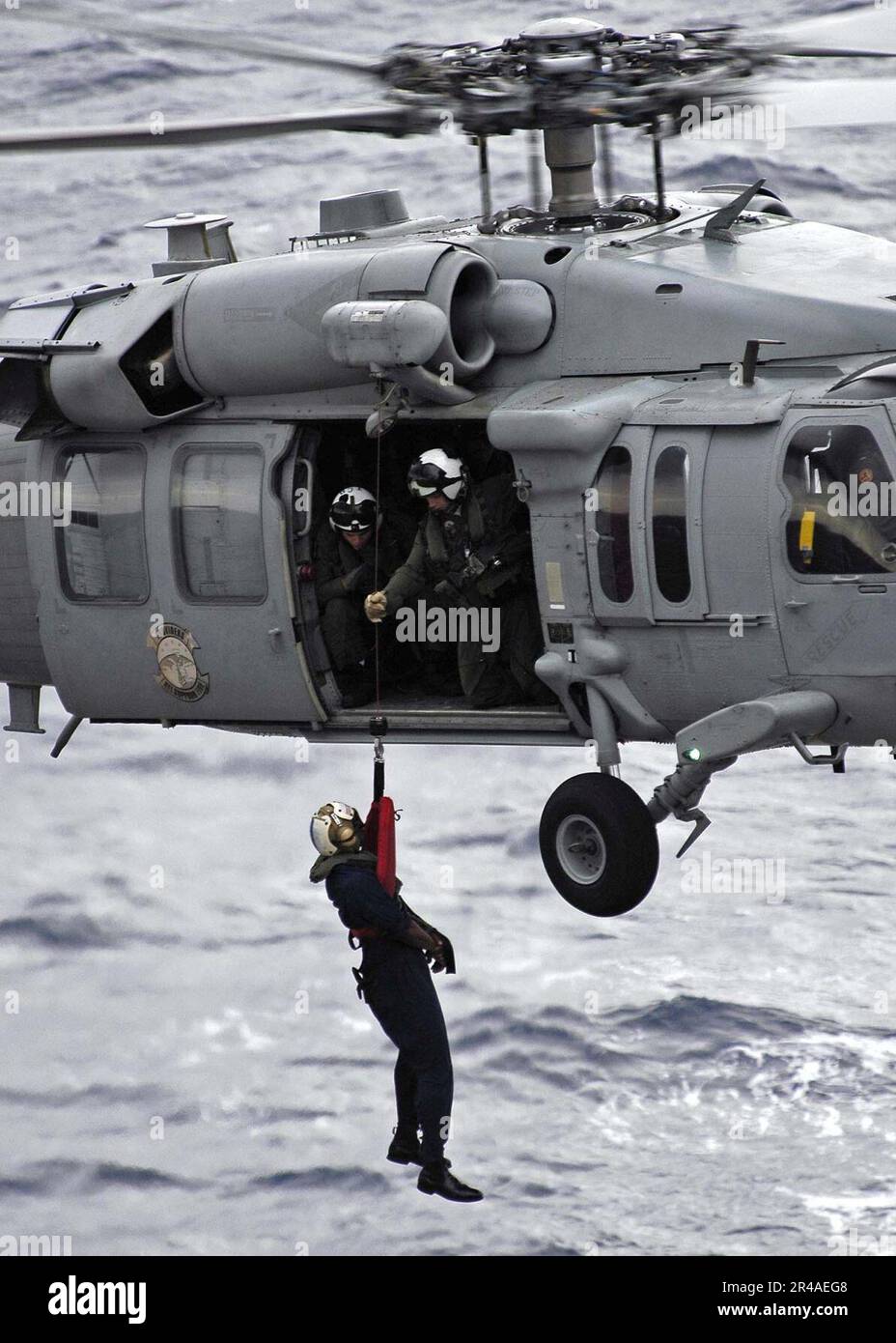 US Navy An MH-60S Knighthawk assigned to Helicopter Combat Support Squadron Five (HC-5) hoists a ...