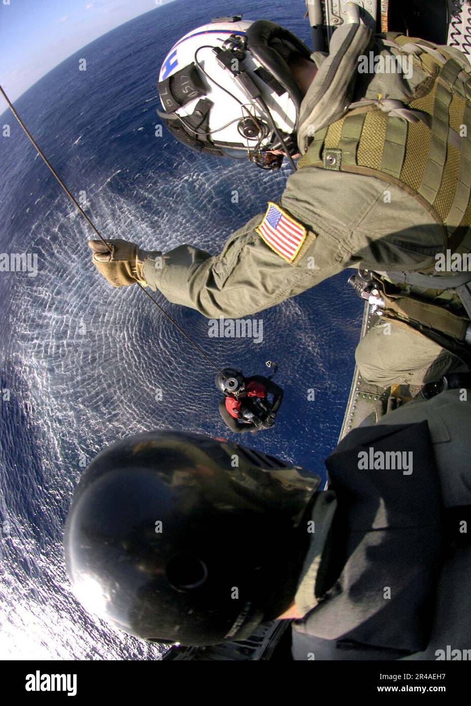 US Navy Aviation Ordnanceman 1st Class is hoisted aboard an SH-60F ...