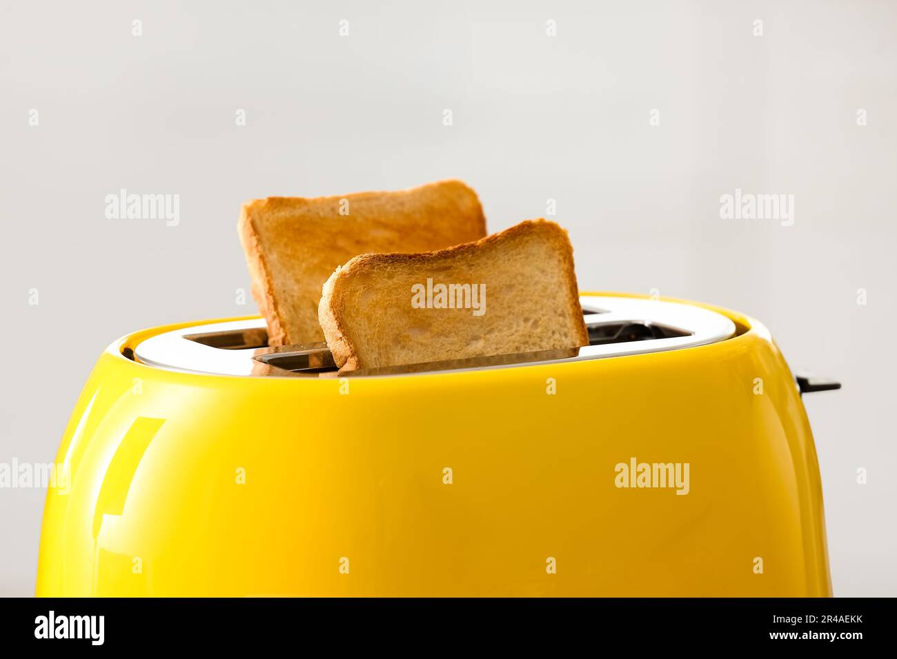 Modern toaster with crispy bread slices, closeup Stock Photo - Alamy
