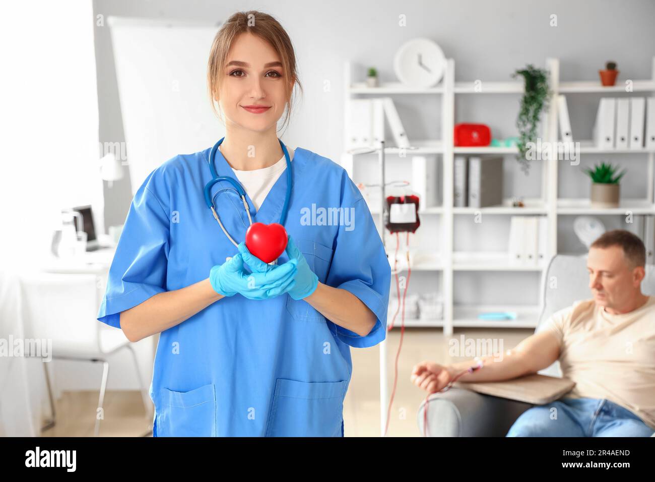 Female nurse with heart in clinic Stock Photo - Alamy