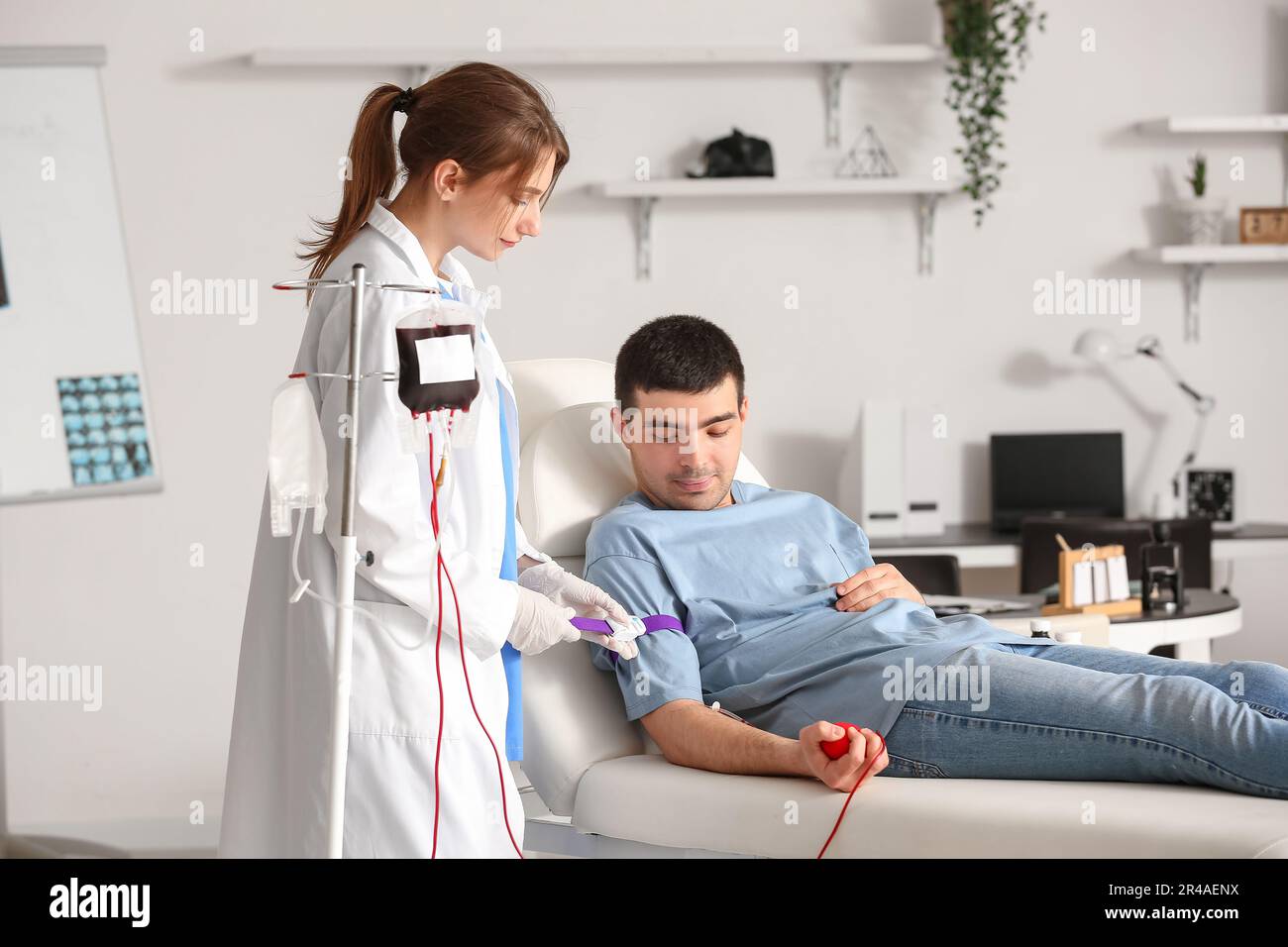 Female doctor taking blood hi-res stock photography and images - Alamy