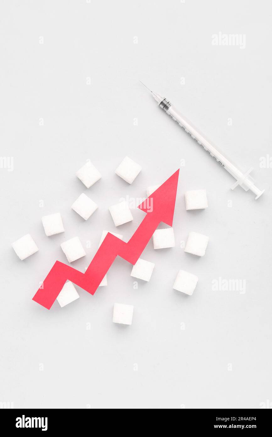 Sugar cubes with syringe for insulin injection and arrow directed ...