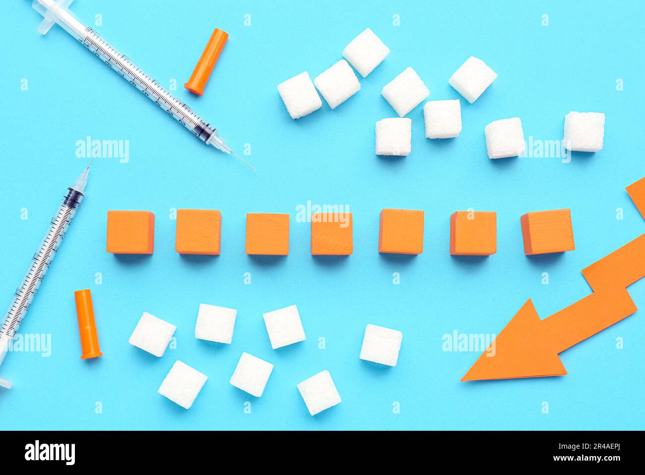 Word INSULIN with syringes, sugar and arrow directed downwards on blue ...
