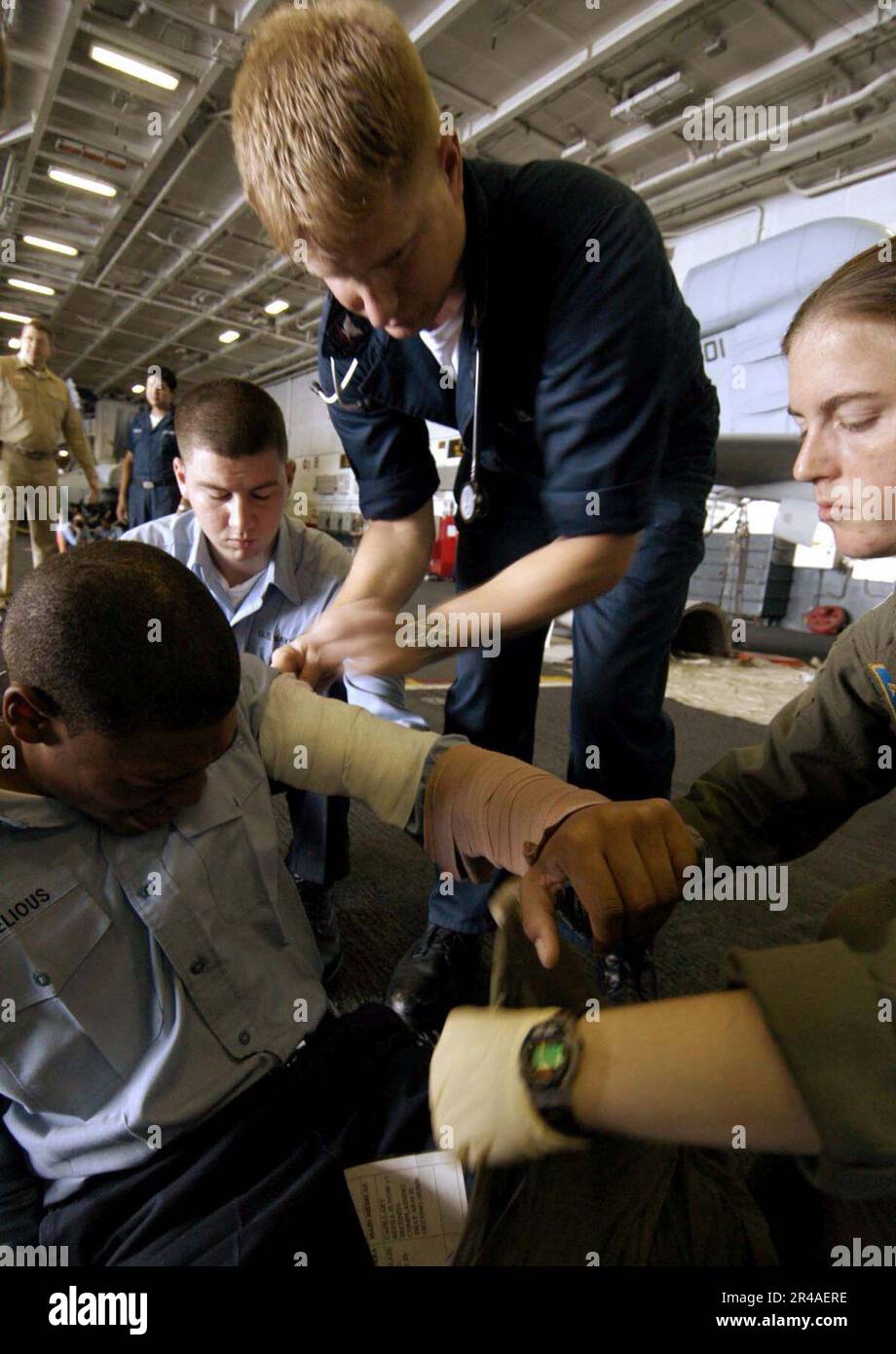 US Navy Sailors participate in a Mass Casualty drill in the hangar bay ...
