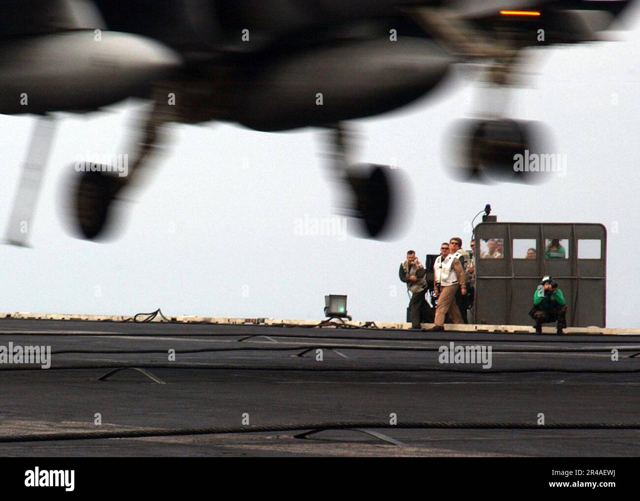 US Navy Landing Signal Officers (LSO) grade the arrested landing of an ...
