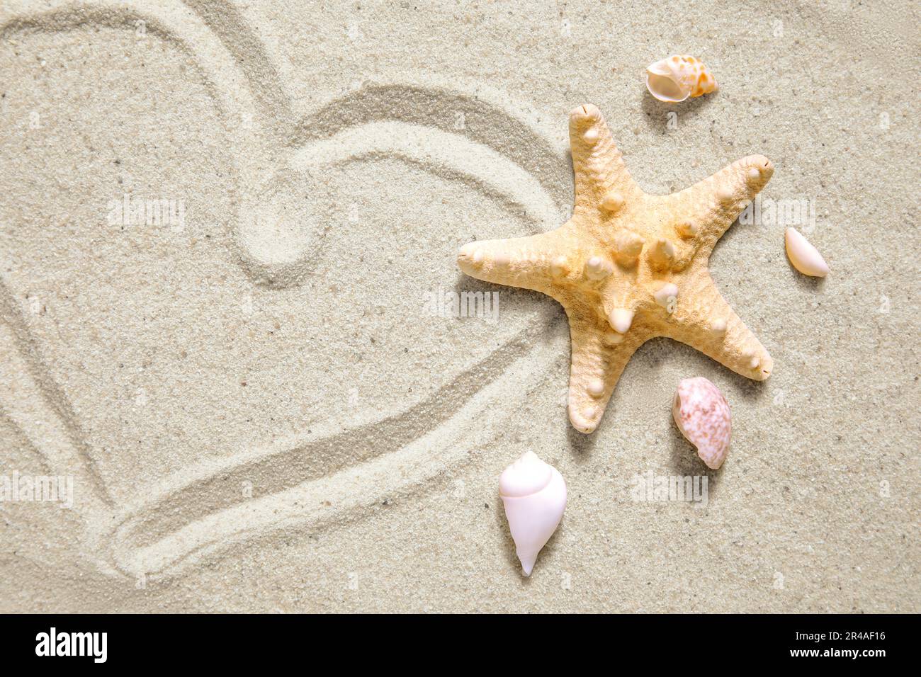 Heart drawing, starfish and seashells on sand Stock Photo - Alamy