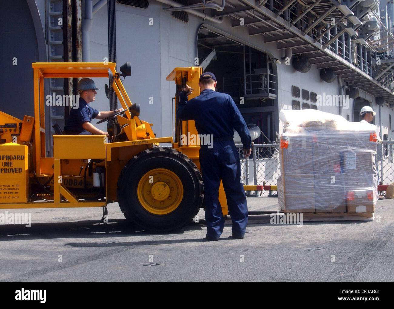 US Navy Sailors prepare to load equipment and supplies aboard the ...