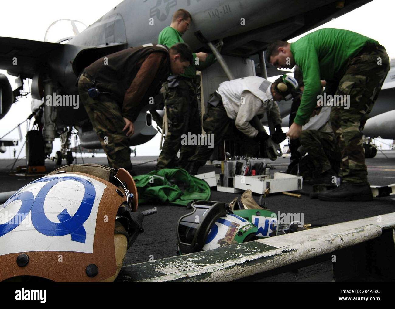 US Navy Sailors work on the tail hook of an EA-6B Prowler on the flight ...