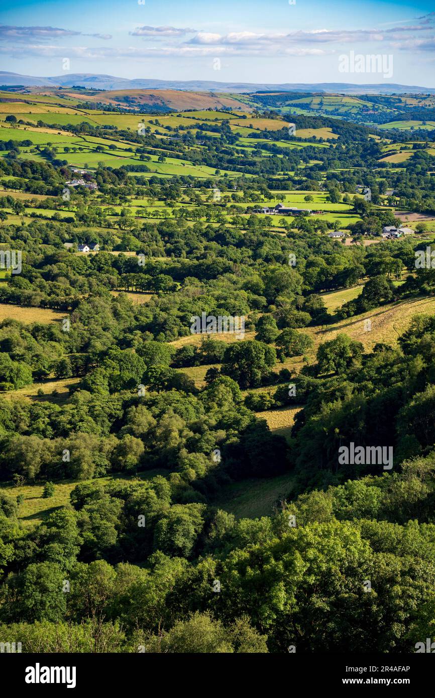 An aerial shot of a stunning mountain range in a rural area, with lush ...