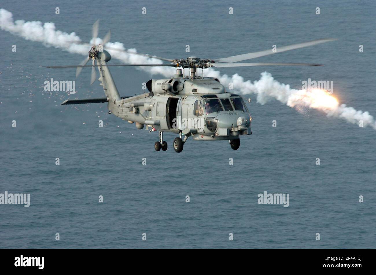 US Navy An SH-60B Seahawk fires-off flares during a training exercise ...