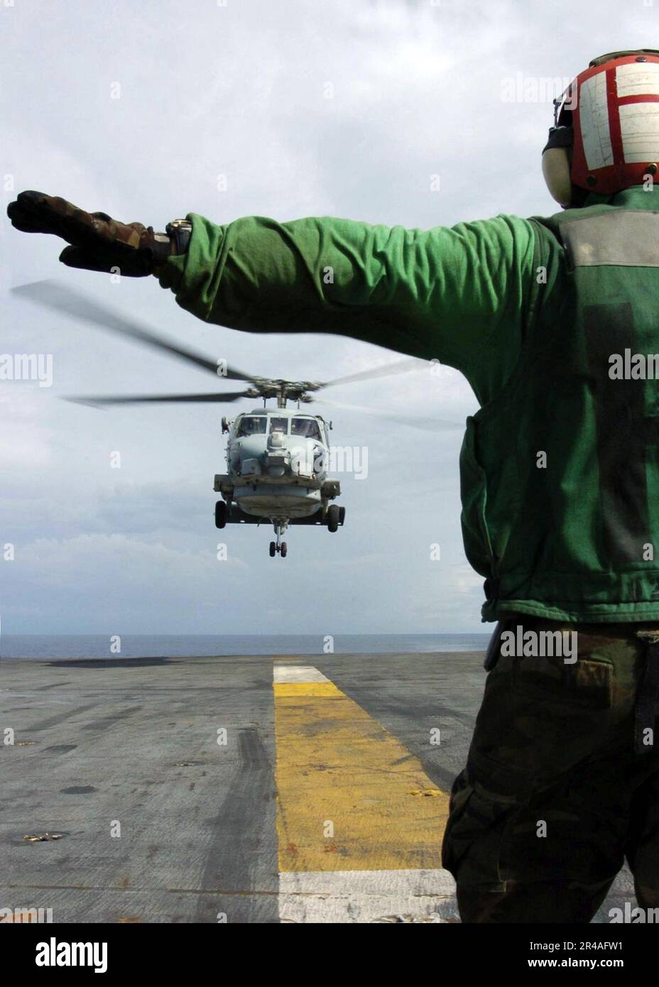 US Navy A Landing Signals Enlisted directs an SH-60B Seahawk assigned ...