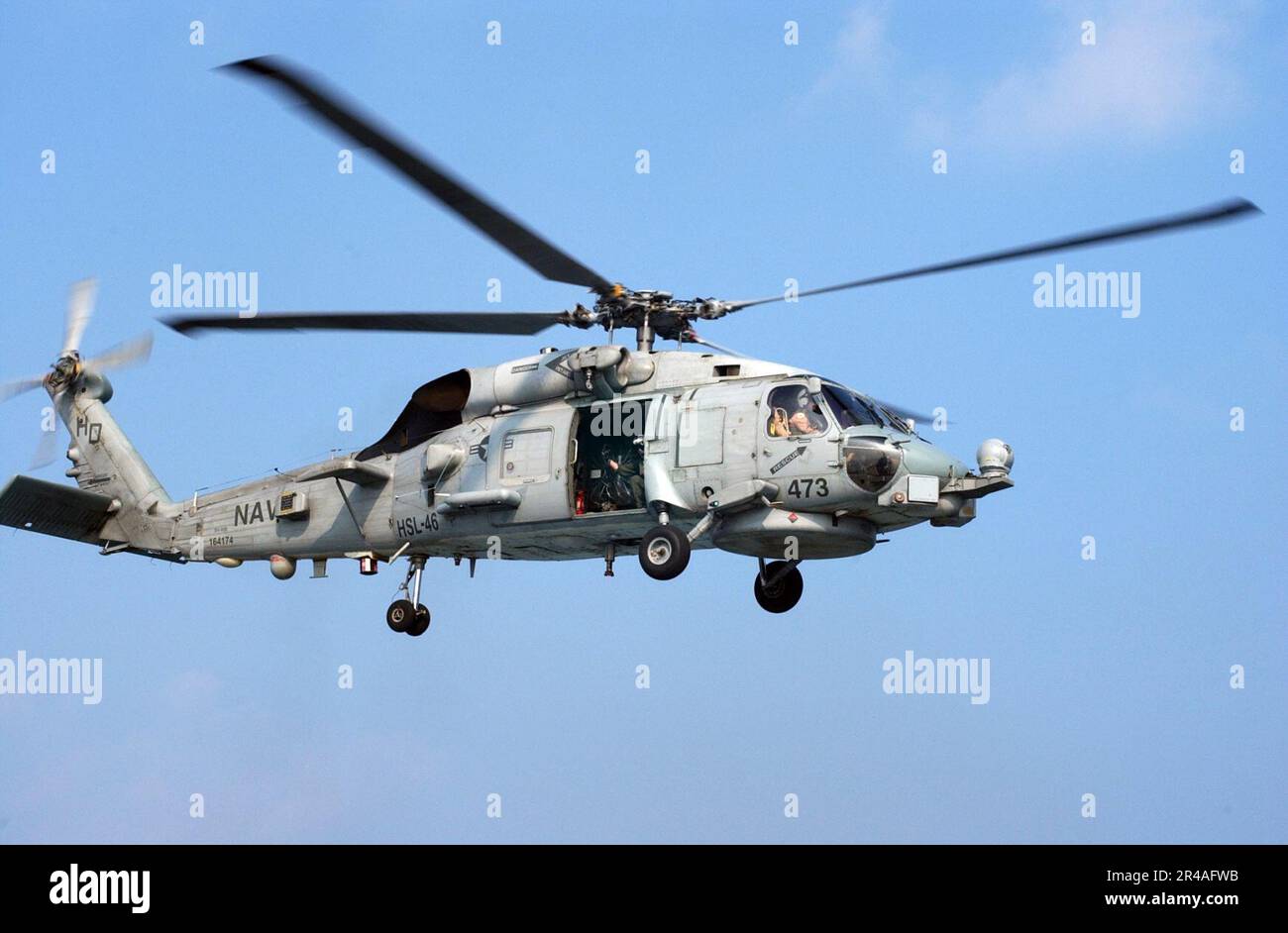 US Navy An SH-60B Seahawk conducts a fly-by of the guided missile ...