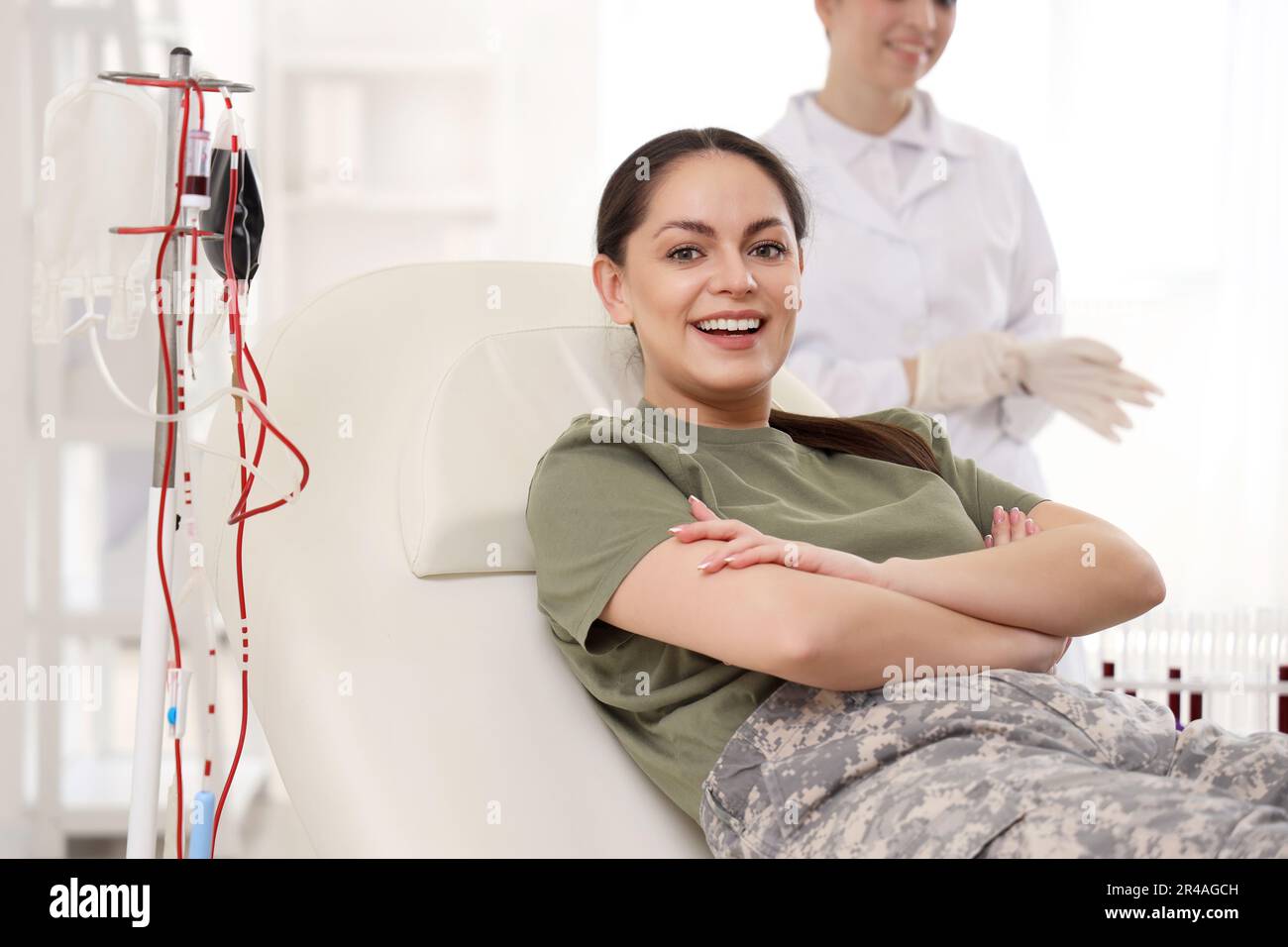 Female soldier donating blood in clinic Stock Photo - Alamy