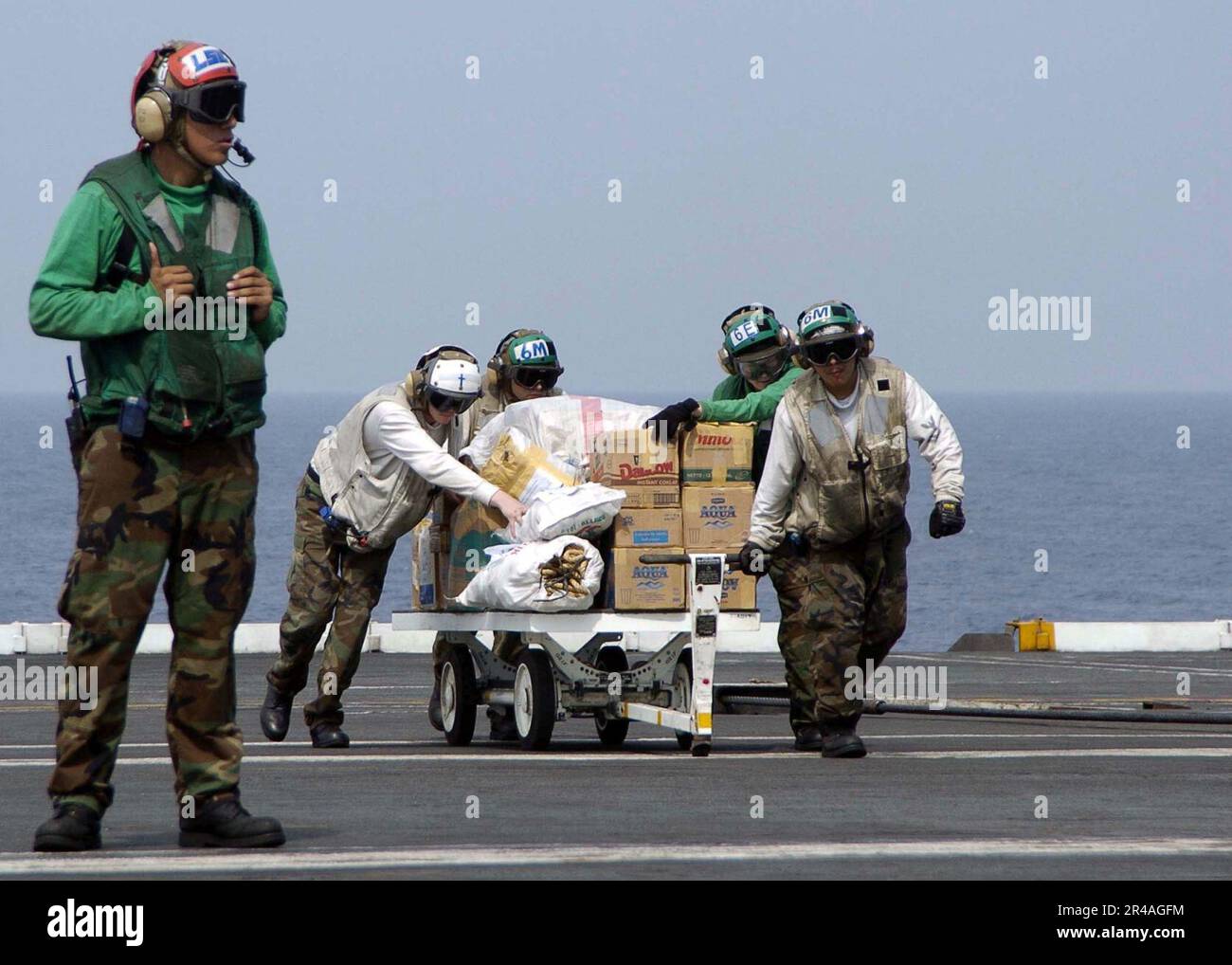 US Navy Boxes of water and food are staged aboard USS Abraham Lincoln ...