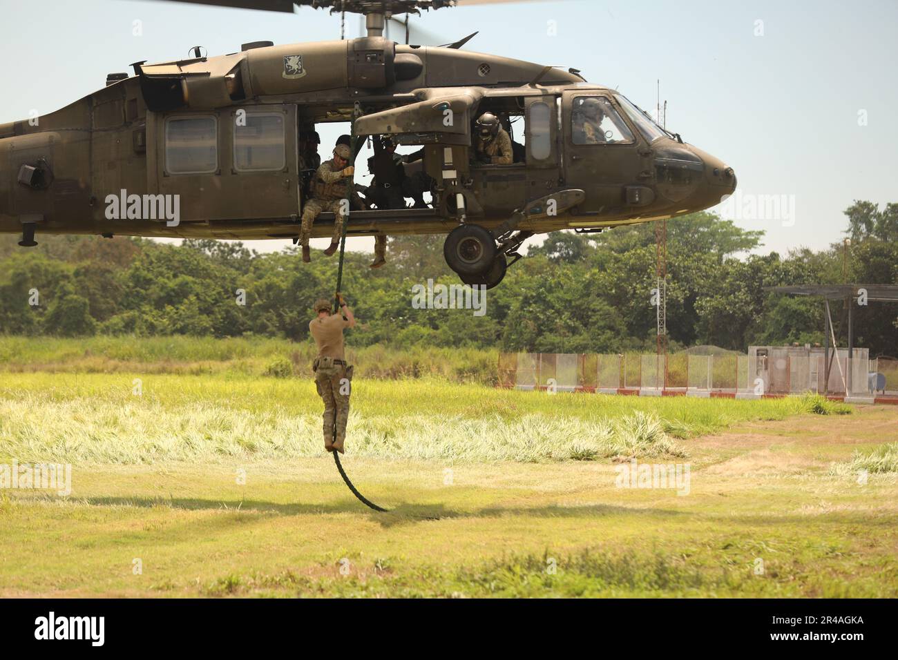 Navy SEAL instructor fast ropes from a UH60 Blackhawk for FRIES ...