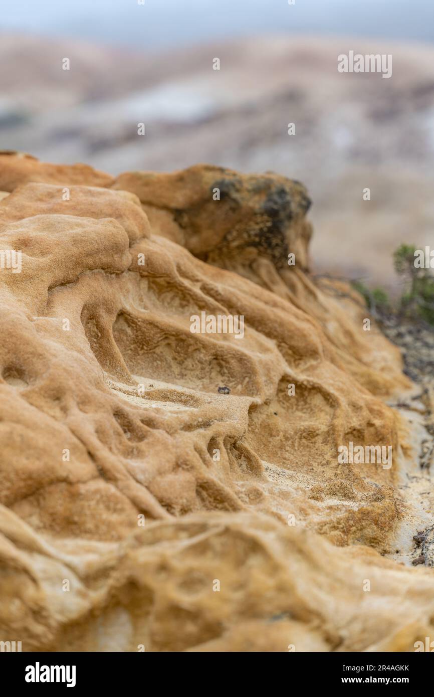 A barren desert landscape situated on the edge of a steep cliff ...
