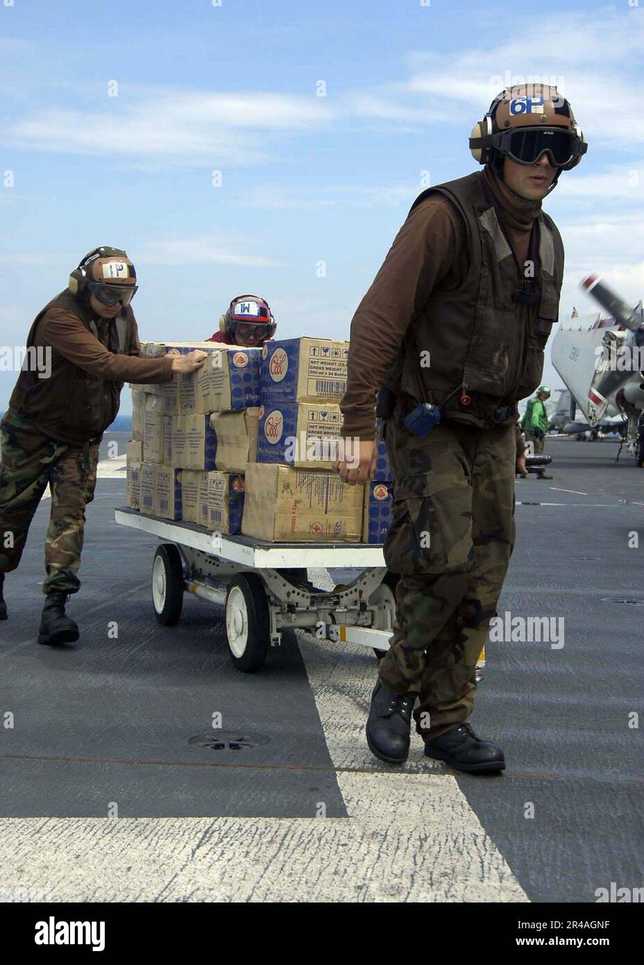 US Navy Sailors assigned to Carrier Air Wing Two (CVW-2) use a weapons ...