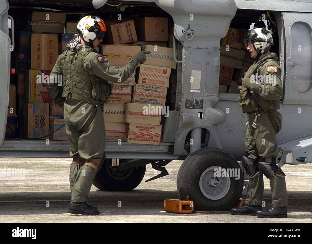 US Navy Air crewmen prepare to board an HH-60H Seahawk helicopter that ...