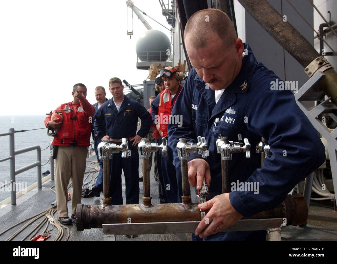 US Navy Hull Maintenance Technician 1st Class prepares to test a fresh ...