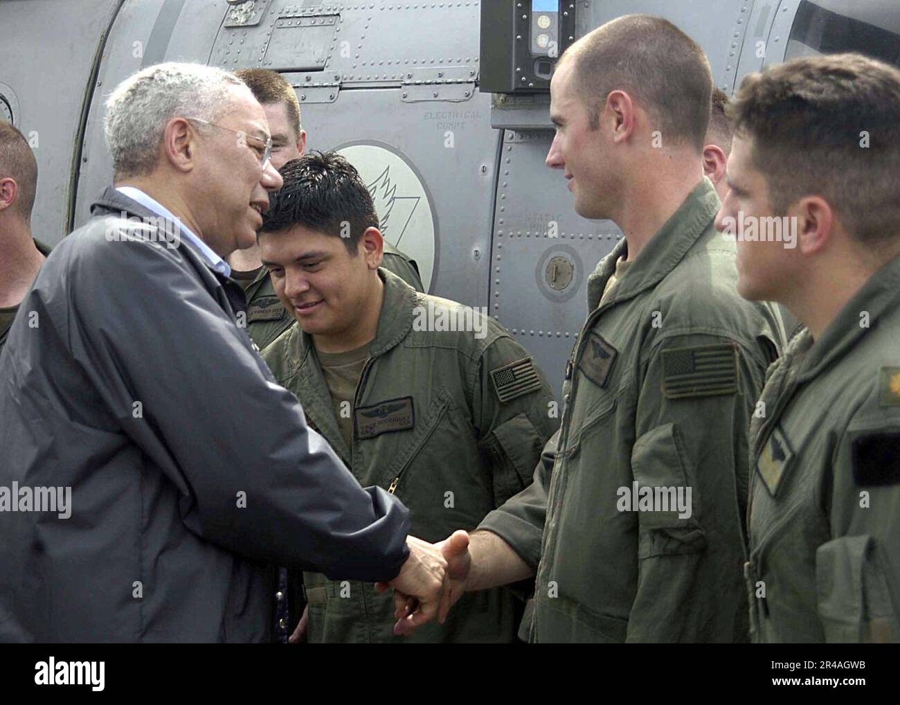 US Navy Secretary of State Colin Powell greets U.S. Navy air crewmen ...
