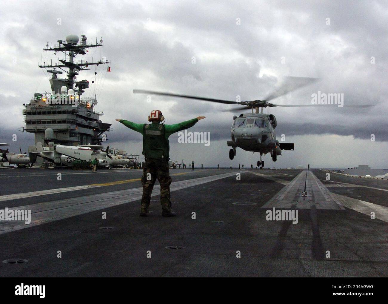 US Navy A Landing Signals Enlisted directs an SH-60F Seahawk to a safe ...