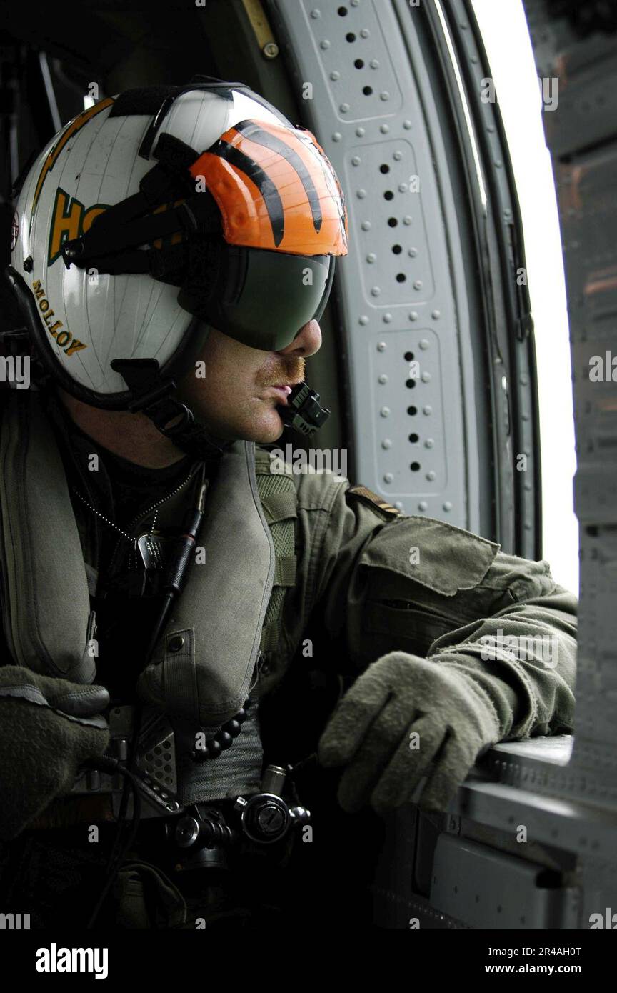 US Navy Aviation Structural Mechanic 1st Class looks out the window of ...