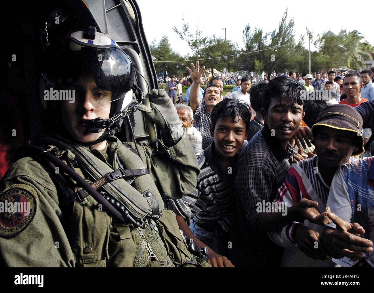 US Navy Citizens of Meulaboh, Sumatra, Indonesia, swarm the cabin of a ...