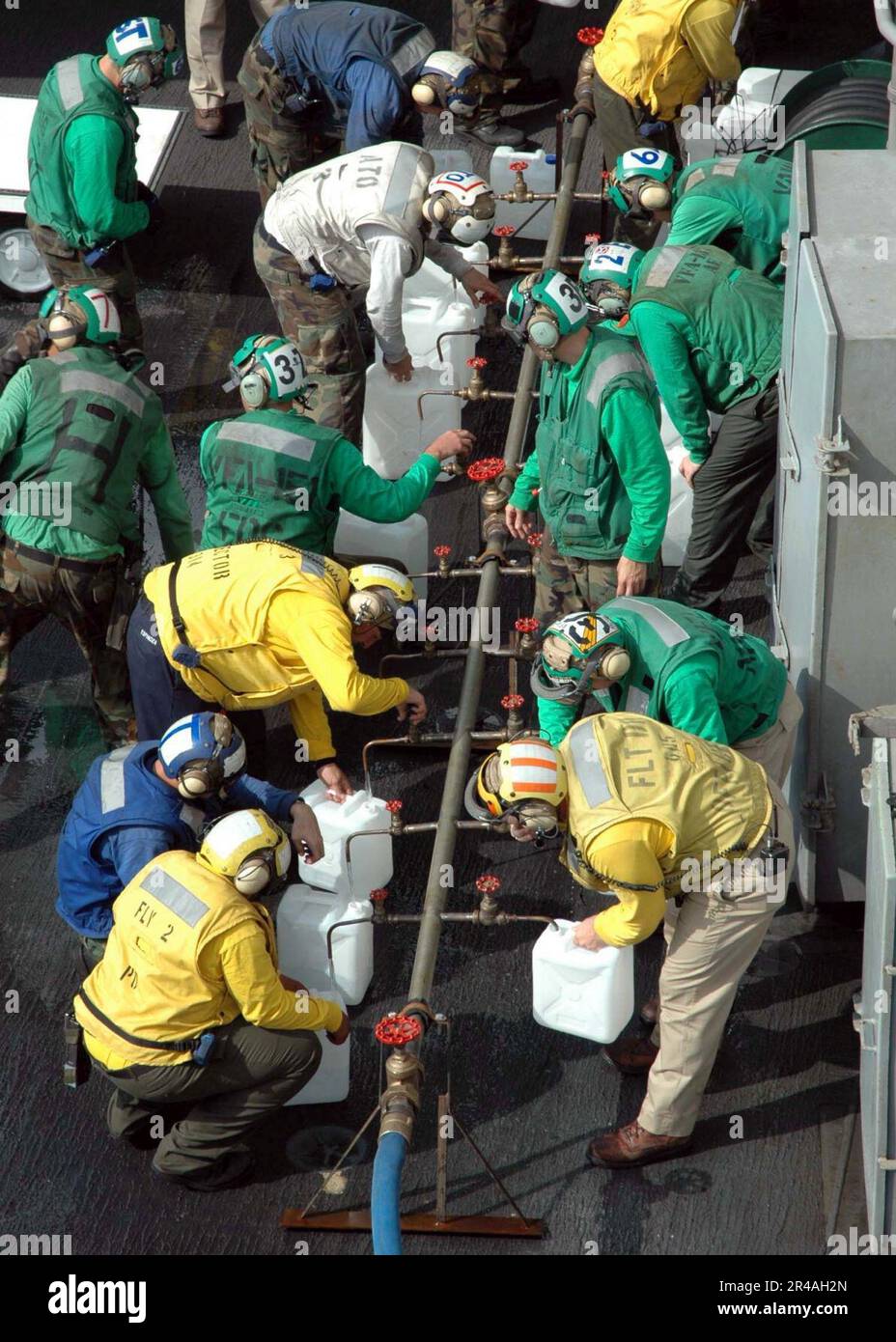 Us Navy Crew Members Aboard Uss Abraham Lincoln Cvn 72 Fill Jugs With