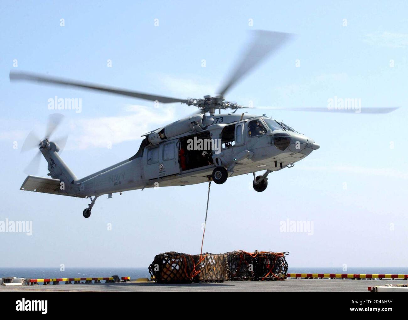 US Navy An MH-60S Knighthawk helicopter prepares to depart with relief ...