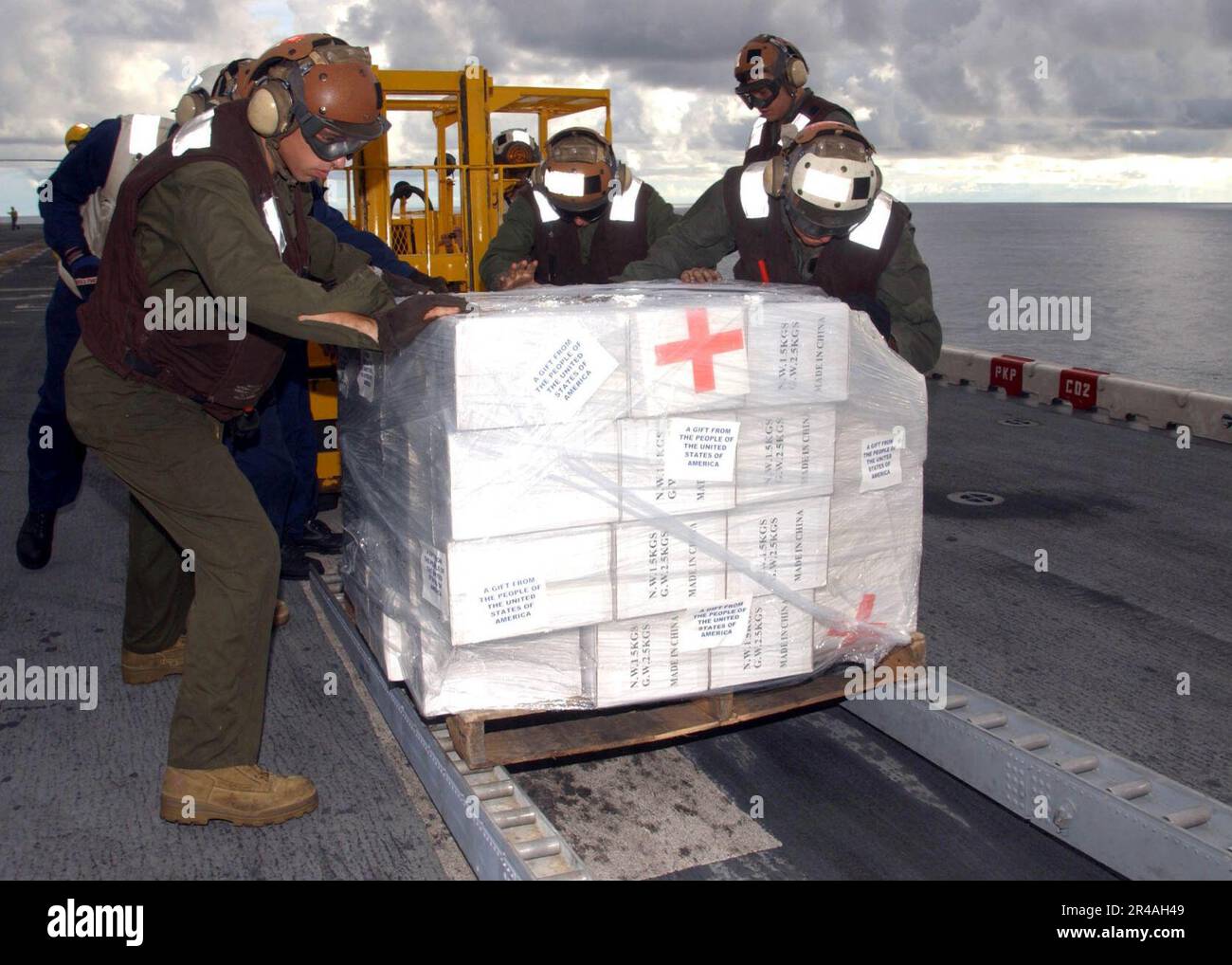 US Navy Marines assigned to the Combat Cargo division aboard the ...