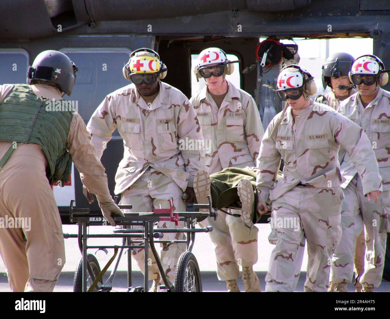 US Navy Navy Corpsmen offload an injured person from a UH-60A Black ...