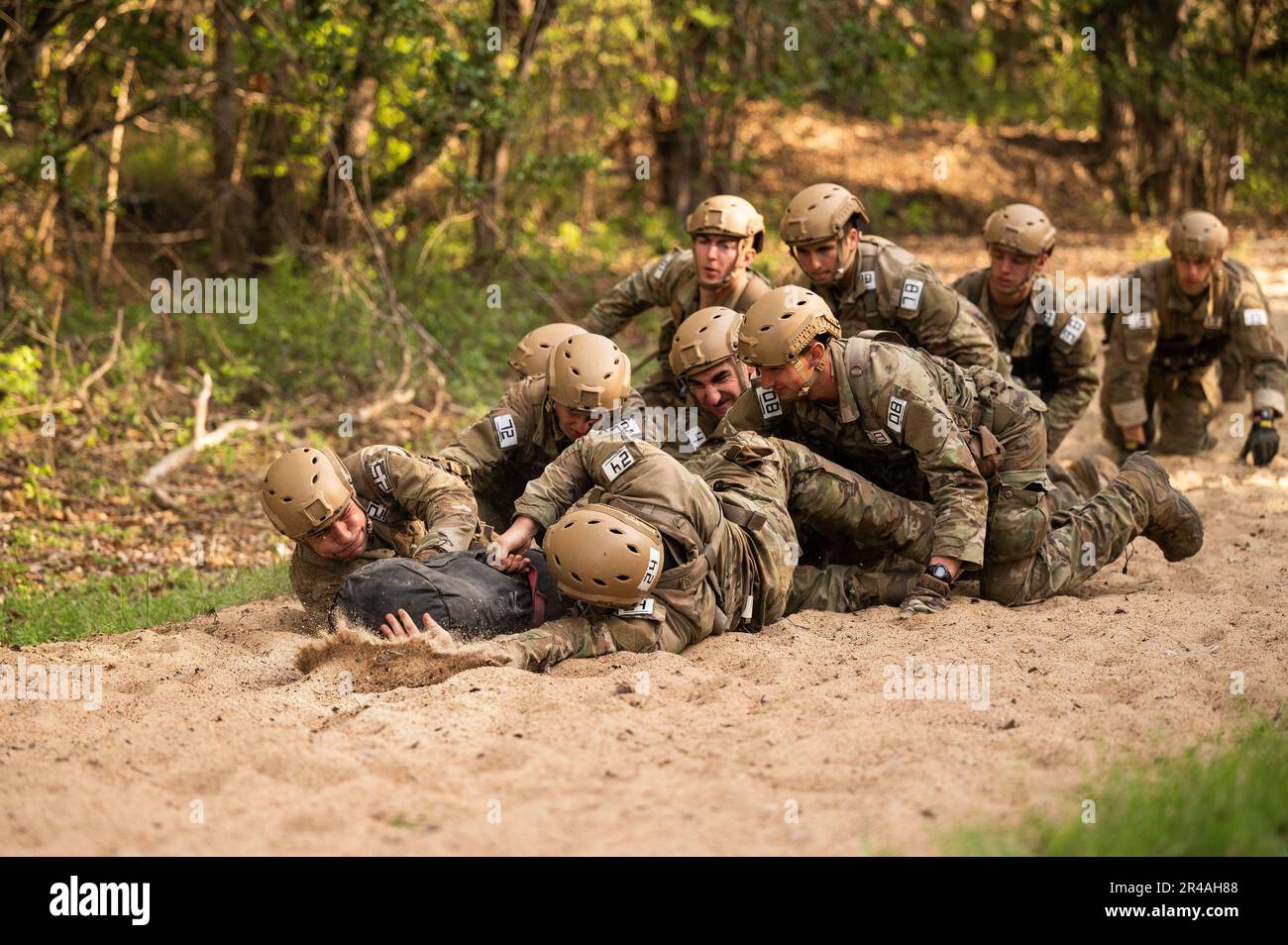 As teams, candidates maneuver an obstacle course during the Special ...