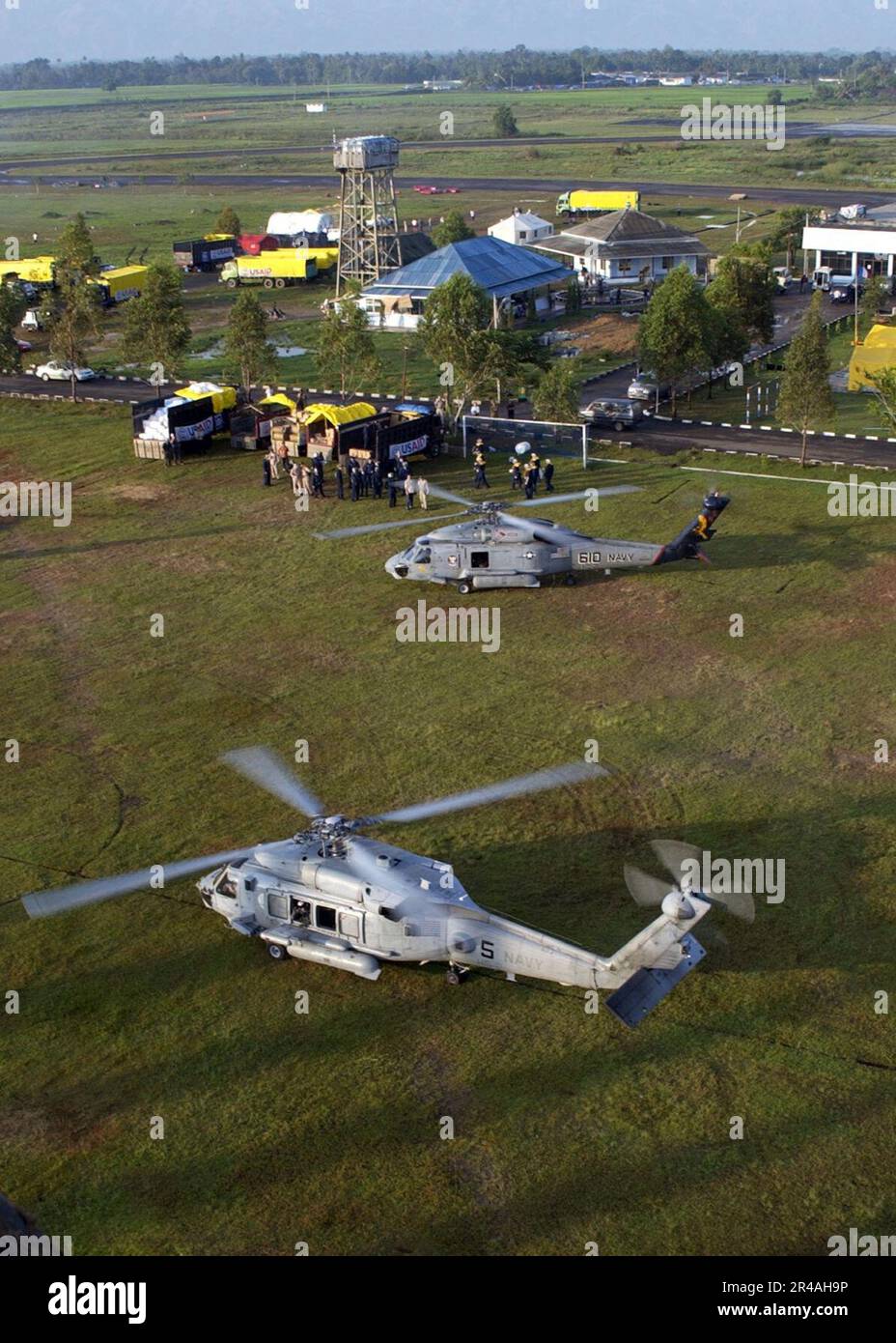 US Navy U.S. Navy Seahawk helicopters land in a soccer field to bring ...