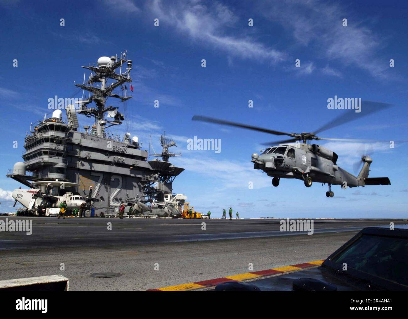 US Navy A SH-60B Seahawk helicopter prepares to land on the flight deck ...
