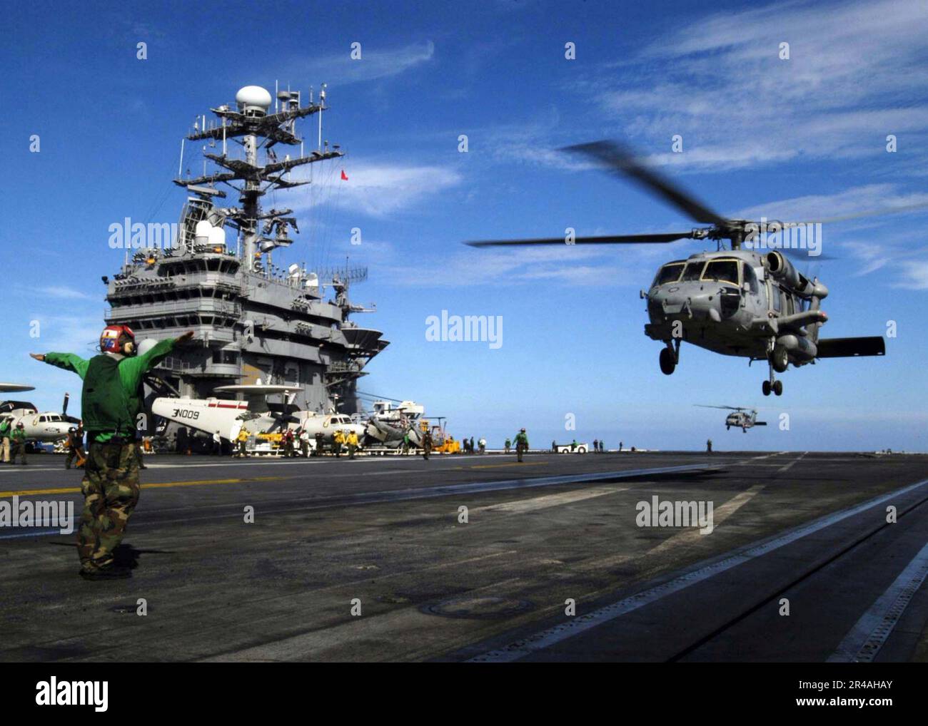 US Navy Seahawk helicopters prepares to land on the flight deck aboard USS Abraham Lincoln (CVN ...