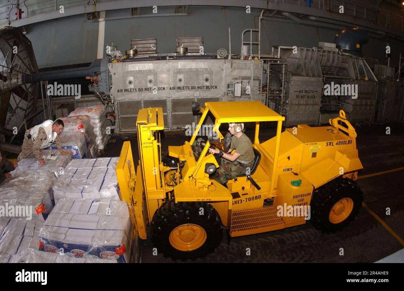 US Navy U.S. Marines load relief supplies aboard a Landing Craft Air ...