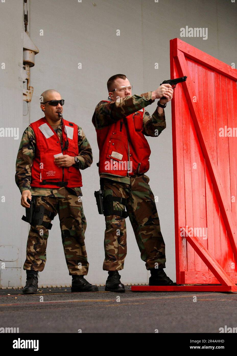 US Navy Senior Chief Master-at-Arms left, observes Master-at-Arms 1st ...