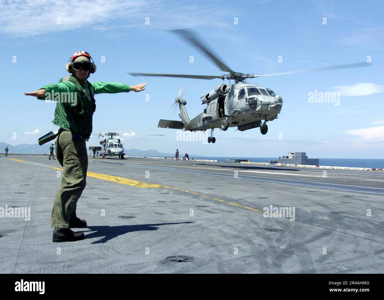 US Navy A Landing Signals Enlisted man directs an HH-60H Seahawk to a ...
