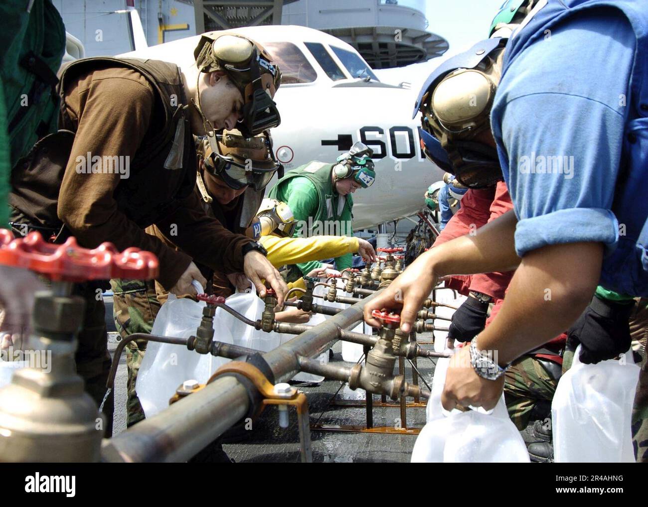 Us Navy Crew Members Aboard Uss Abraham Lincoln Cvn 72 Fill Jugs With
