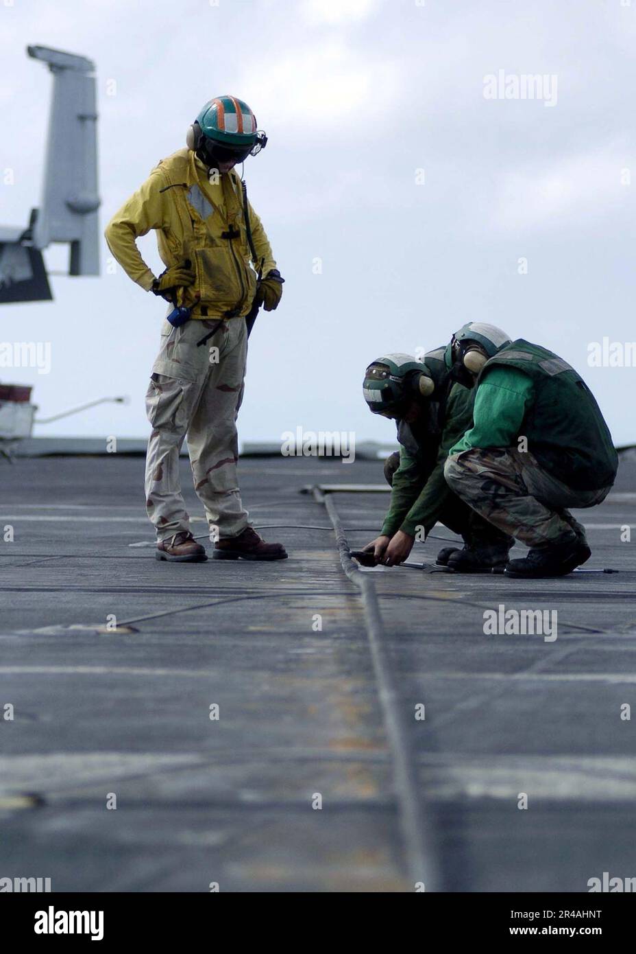 US Navy Flight deck Personnel make quick adjustments to the number ...