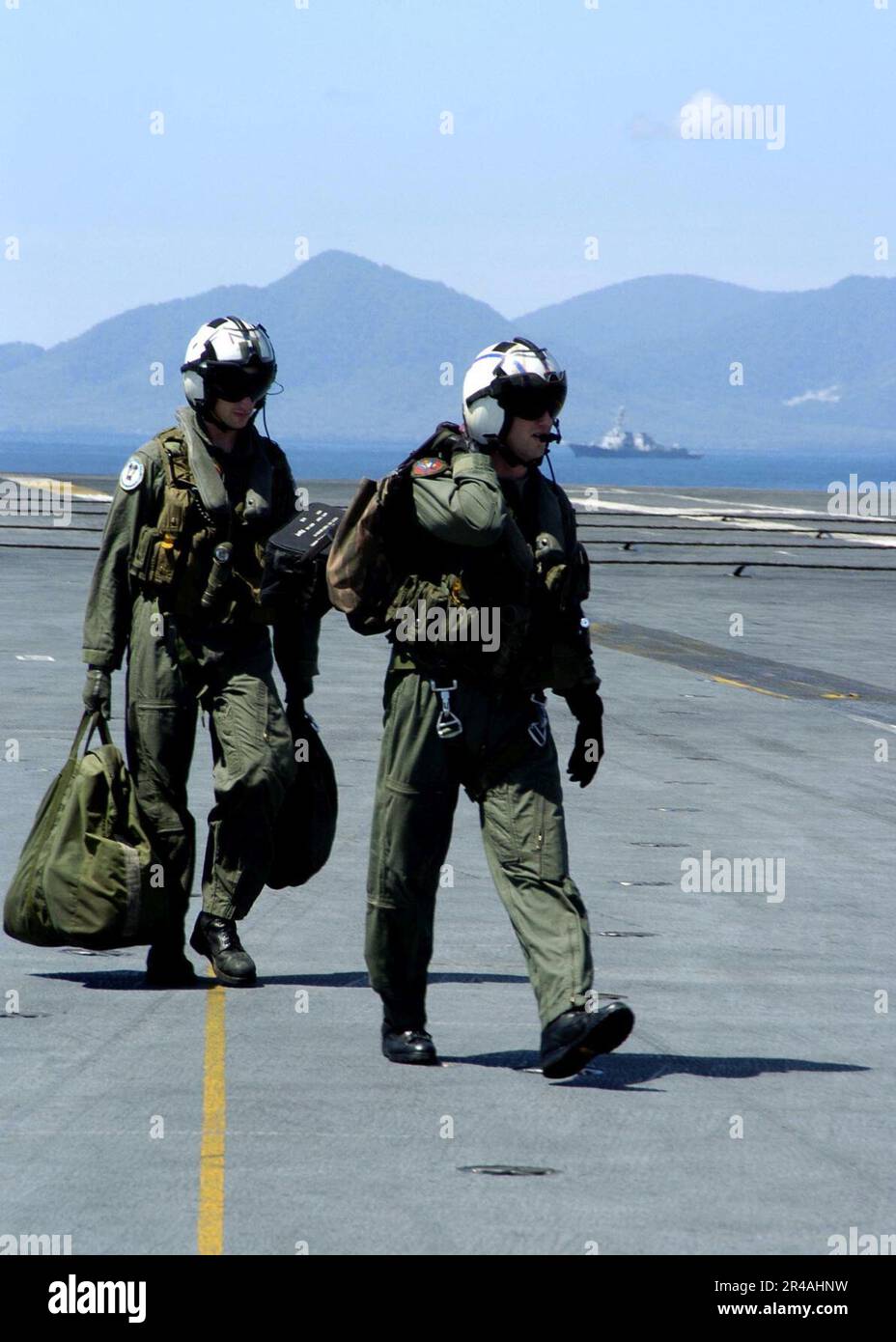 US Navy Pilots walk toward their SH-60F Seahawk on the flight deck ...