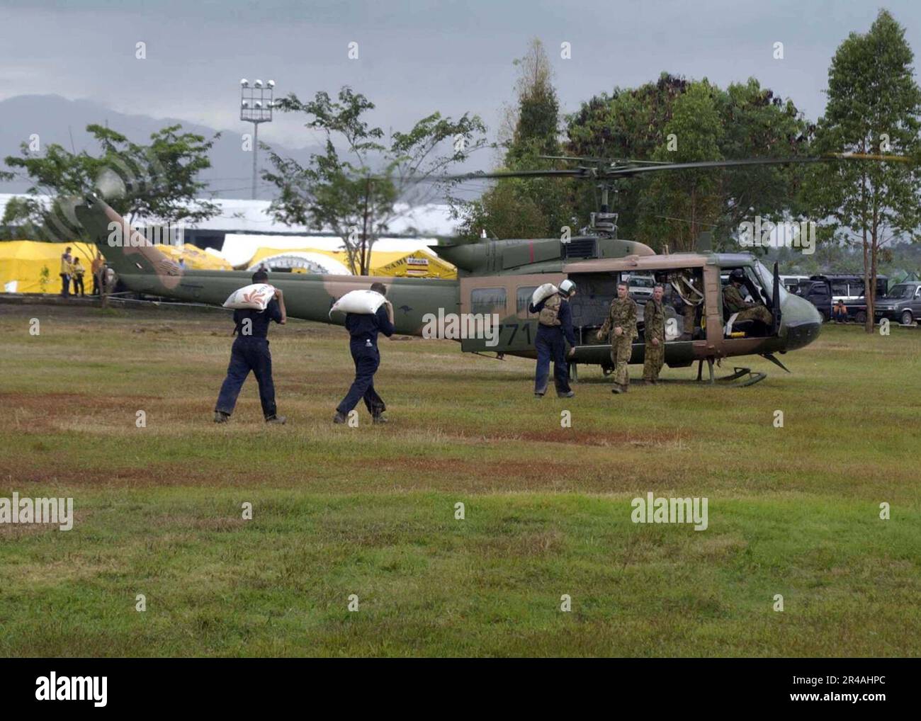 US Navy U.S. Navy Sailors carry relief supplies to an Australian Army ...