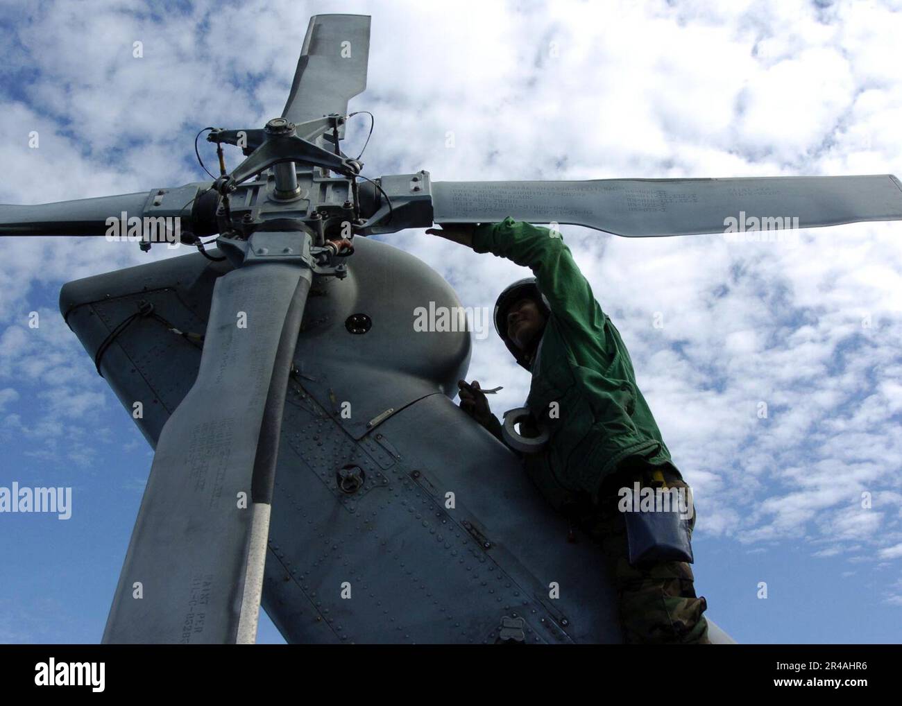 US Navy A Sailor performs maintenance on the tail rotor of an SH-60 ...