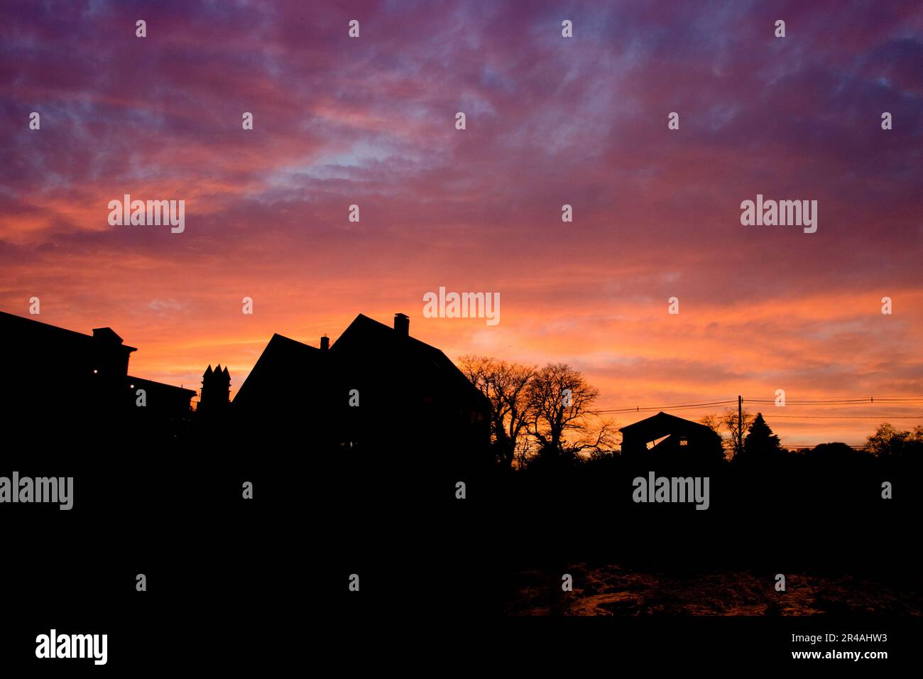 A bright and vibrant sky over an urban landscape featuring buildings ...