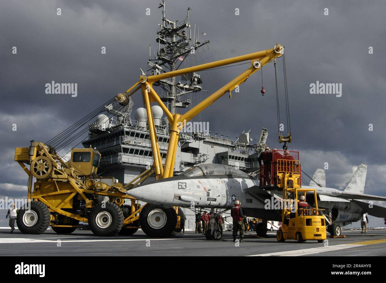 US Navy Crash-and-salvage personnel rig a training skeleton of an F-14 ...