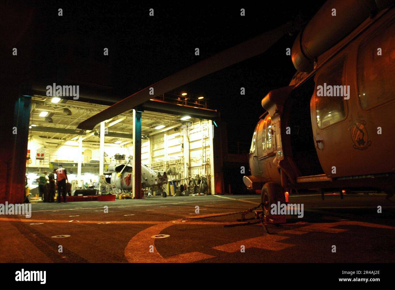 US Navy Sailors perform maintance on MH-60 Knighthawk rotor blade parts ...