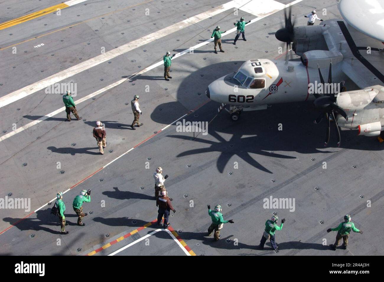US Navy Flight deck personnel create a safety barrier around the ...