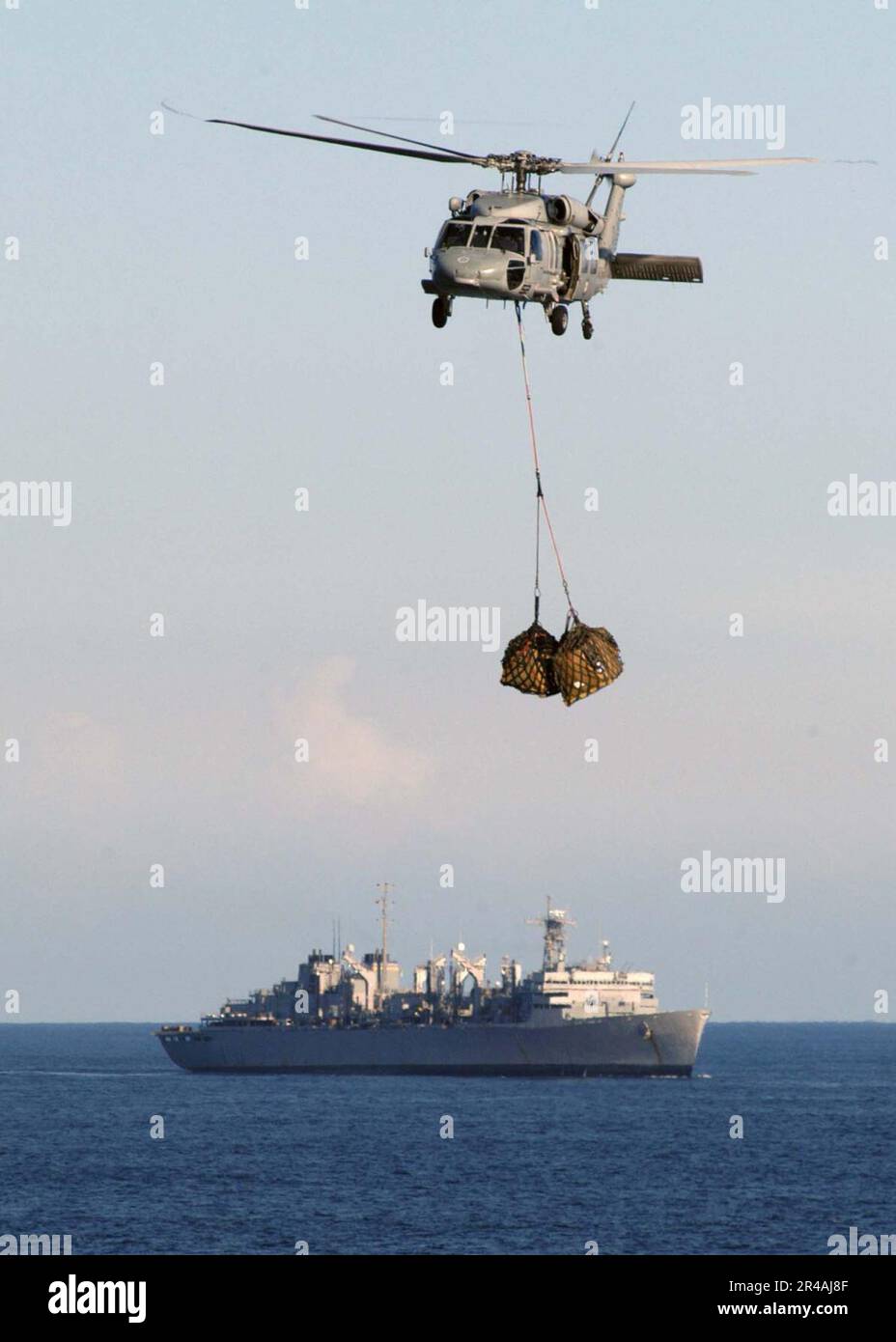 US Navy An MH-60S Knighthawk helicopter transports cargo from the ...
